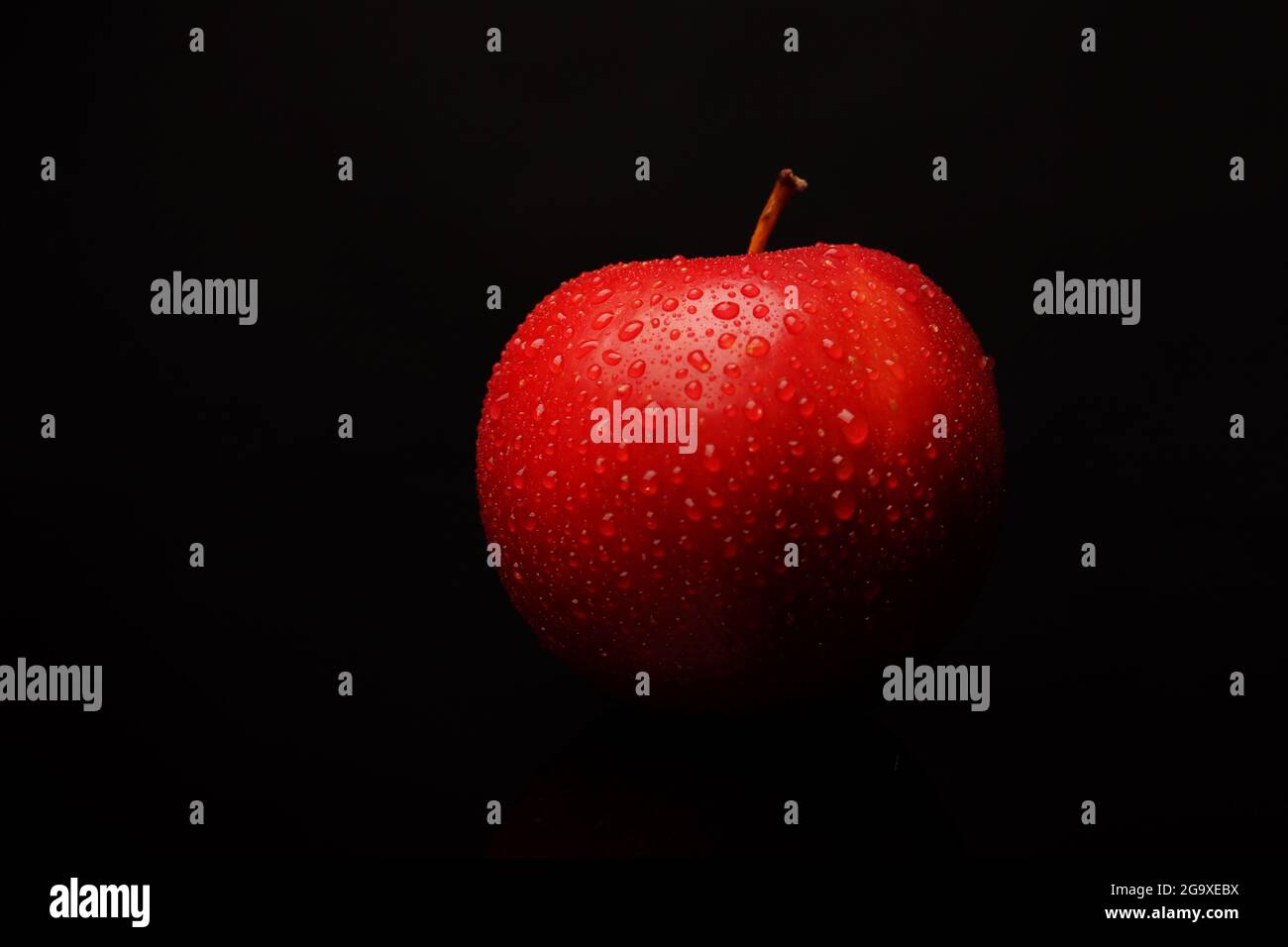 Apple on black background Stock Photo - Alamy