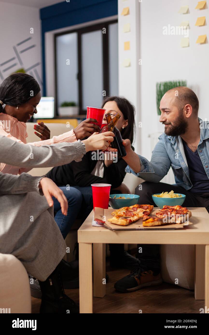 Diverse group of workers having fun after work at office meeting party ...