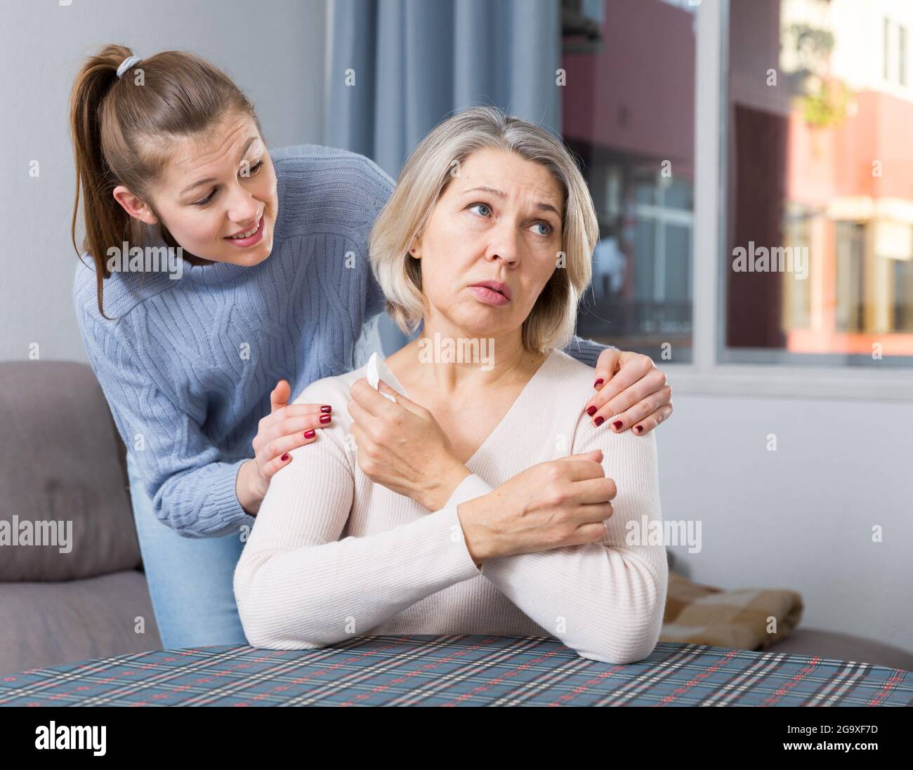 Daughter supporting her mother Stock Photo - Alamy