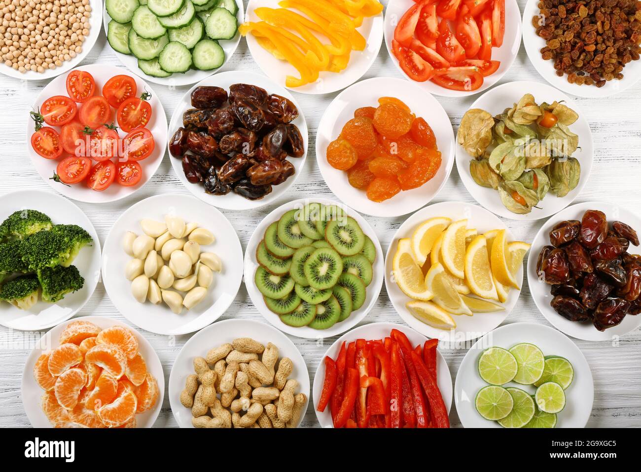 Different products on saucers on wooden table, top view Stock Photo - Alamy