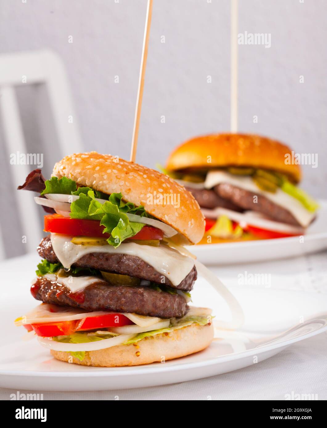 Two delicious double tasty hamburger with beef cutlet and vegetables ...