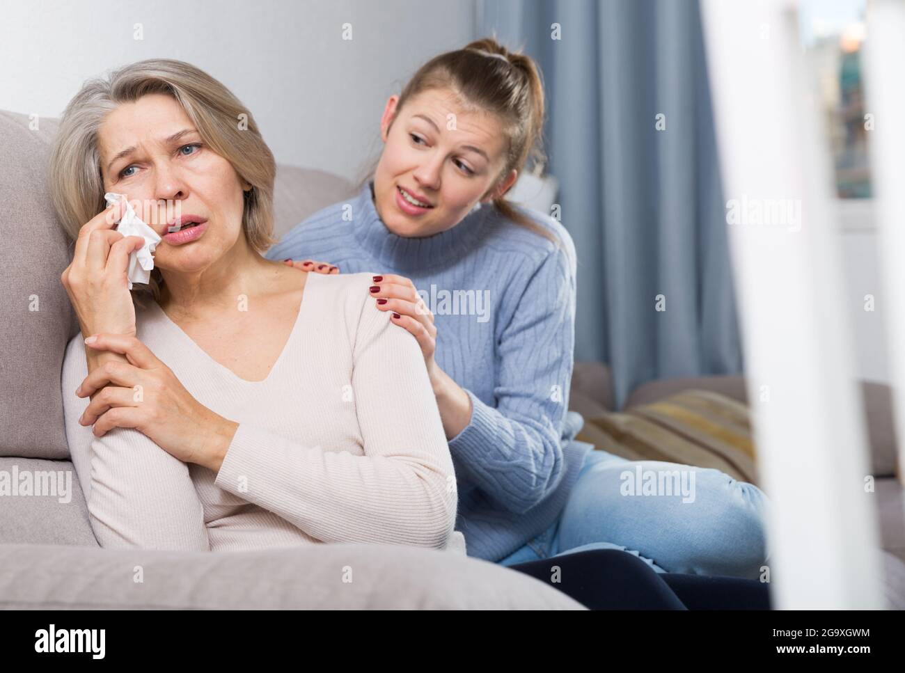 Girl supporting her crying mother Stock Photo - Alamy