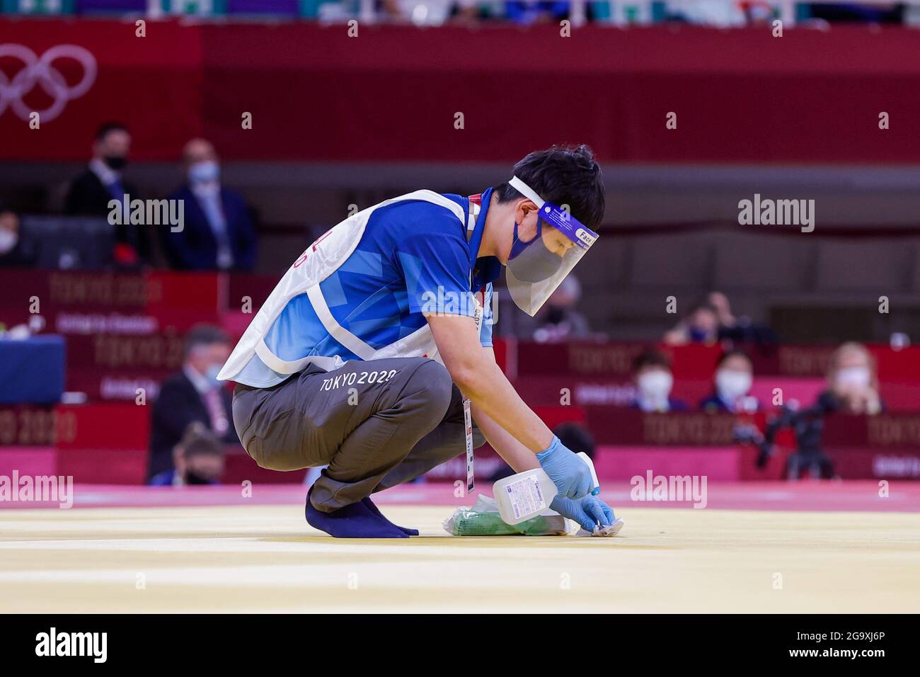 TOKYO, JAPAN - JULY 28: Cleaning of the Tatami competing on Men -90 kg ...