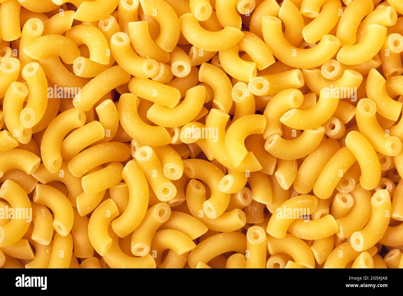 Dry macaroni pasta background Stock Photo - Alamy