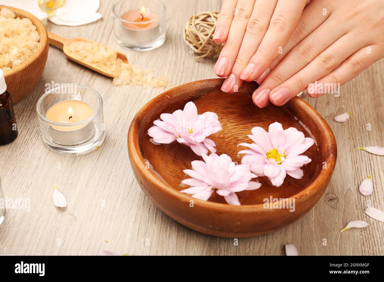 Female hands and bowl of spa water with flowers, closeup Stock Photo ...