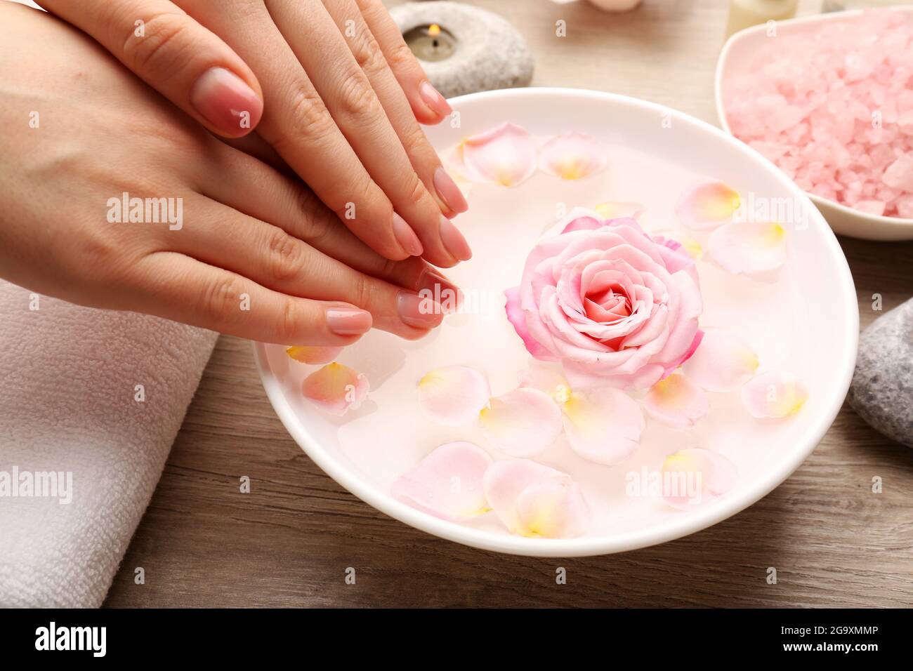 Female hands and bowl of spa water with flowers, closeup Stock Photo ...