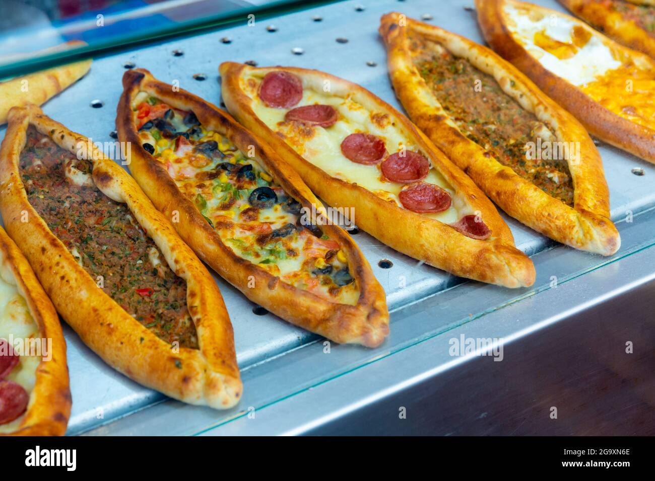 Traditional Turkish pide with various fillings on bakery showcase Stock ...