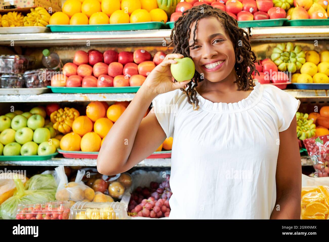 Portrait of African young customer smiling at camera while choosing the ...