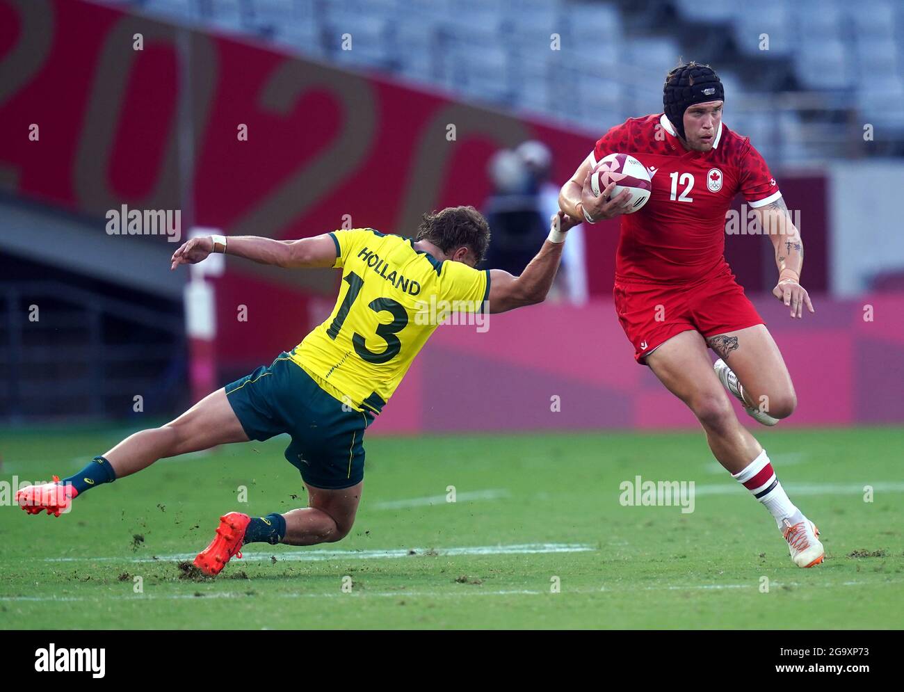 Australia's Lewis Holland (left) attempts to tackle Canada's Jake Thiel ...