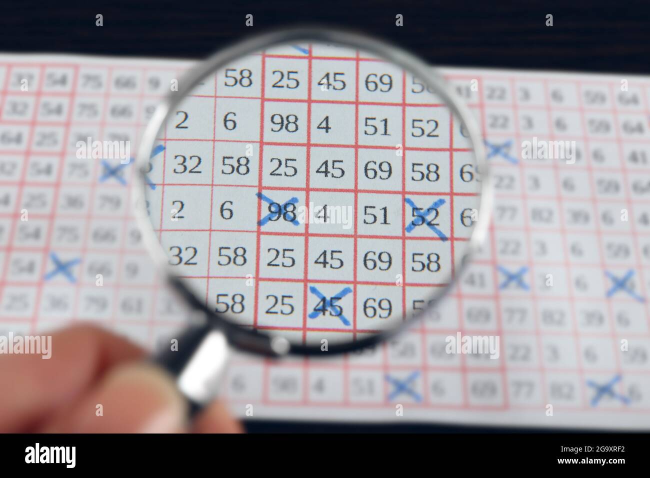 Female hand with magnifier analyzing lottery ticket, closeup Stock ...