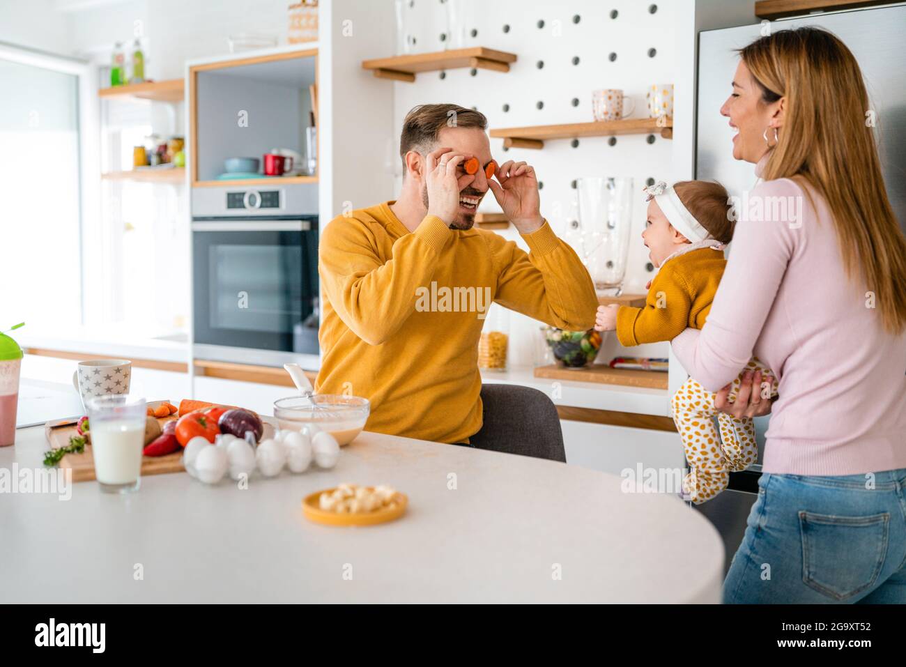Happy family preparing healthy food together in kitchen Stock Photo - Alamy