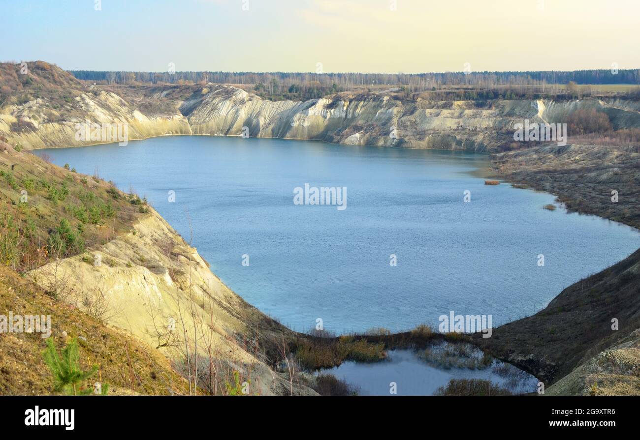 Chalk quarry artificial lakes in autumn season. Technogenic open pit is ...