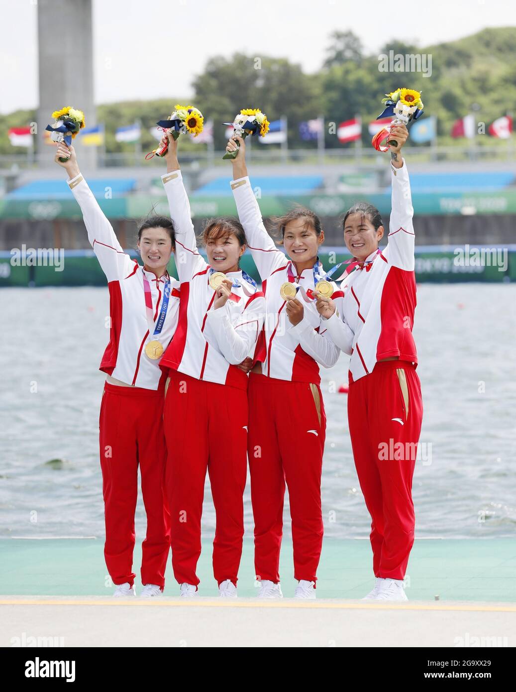 Chinese rowing team members celebrate after winning gold in the women's ...