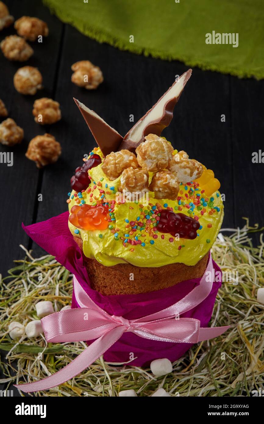 Easter cake with yellow whipped egg whites and sweets Stock Photo - Alamy
