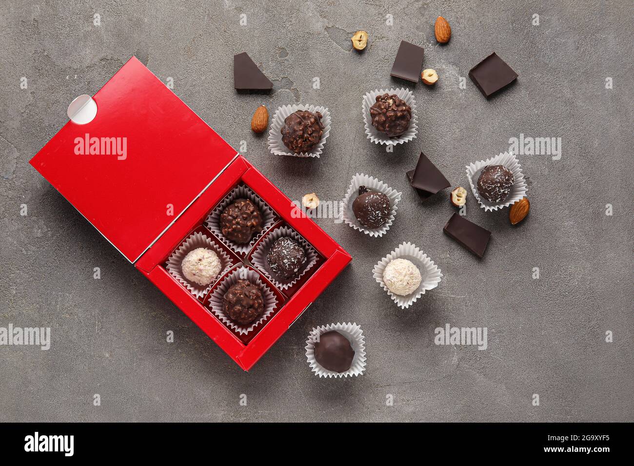 Box with sweet chocolate candies on grunge background Stock Photo - Alamy