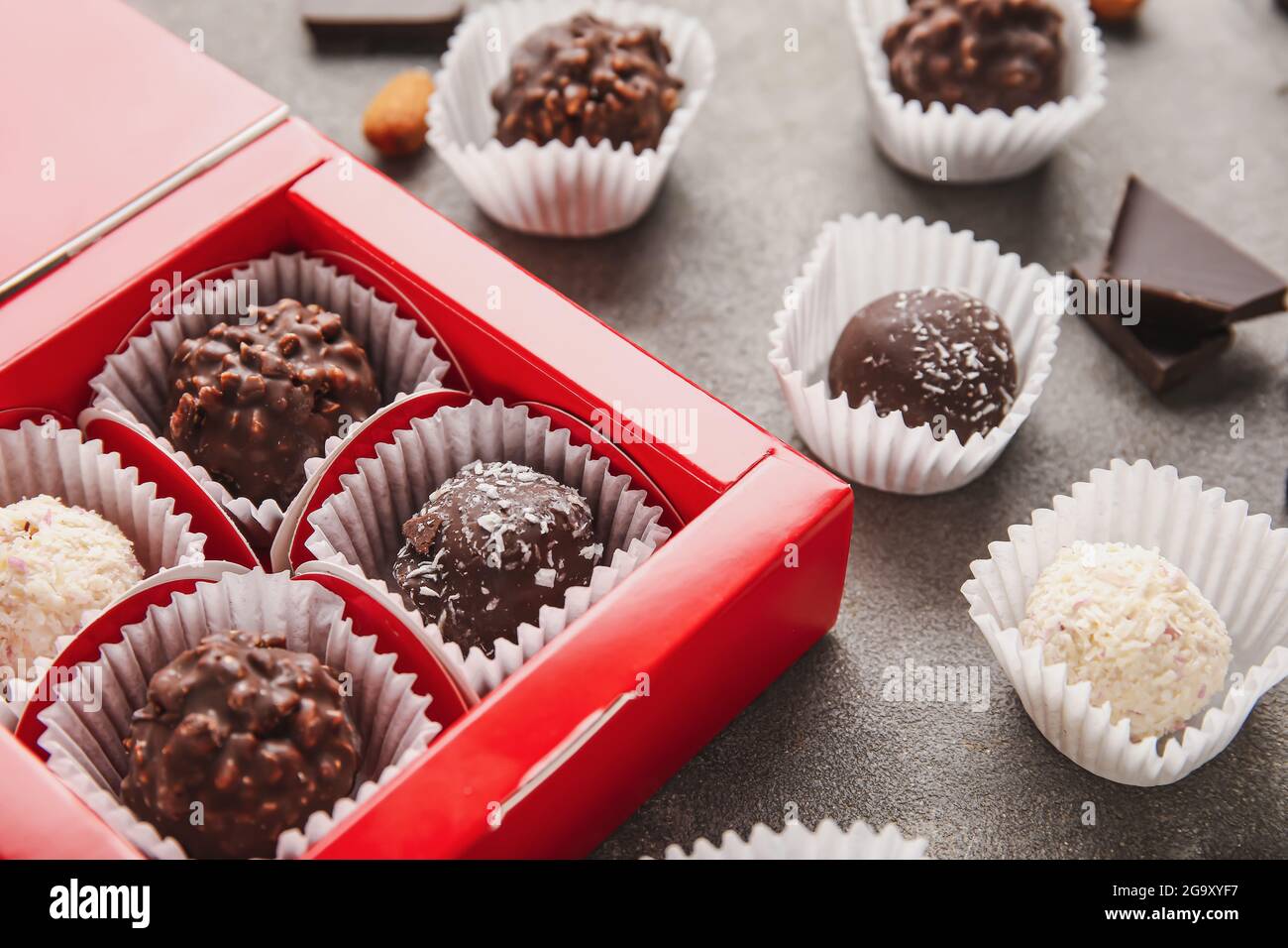 Box with sweet chocolate candies on grunge background Stock Photo - Alamy