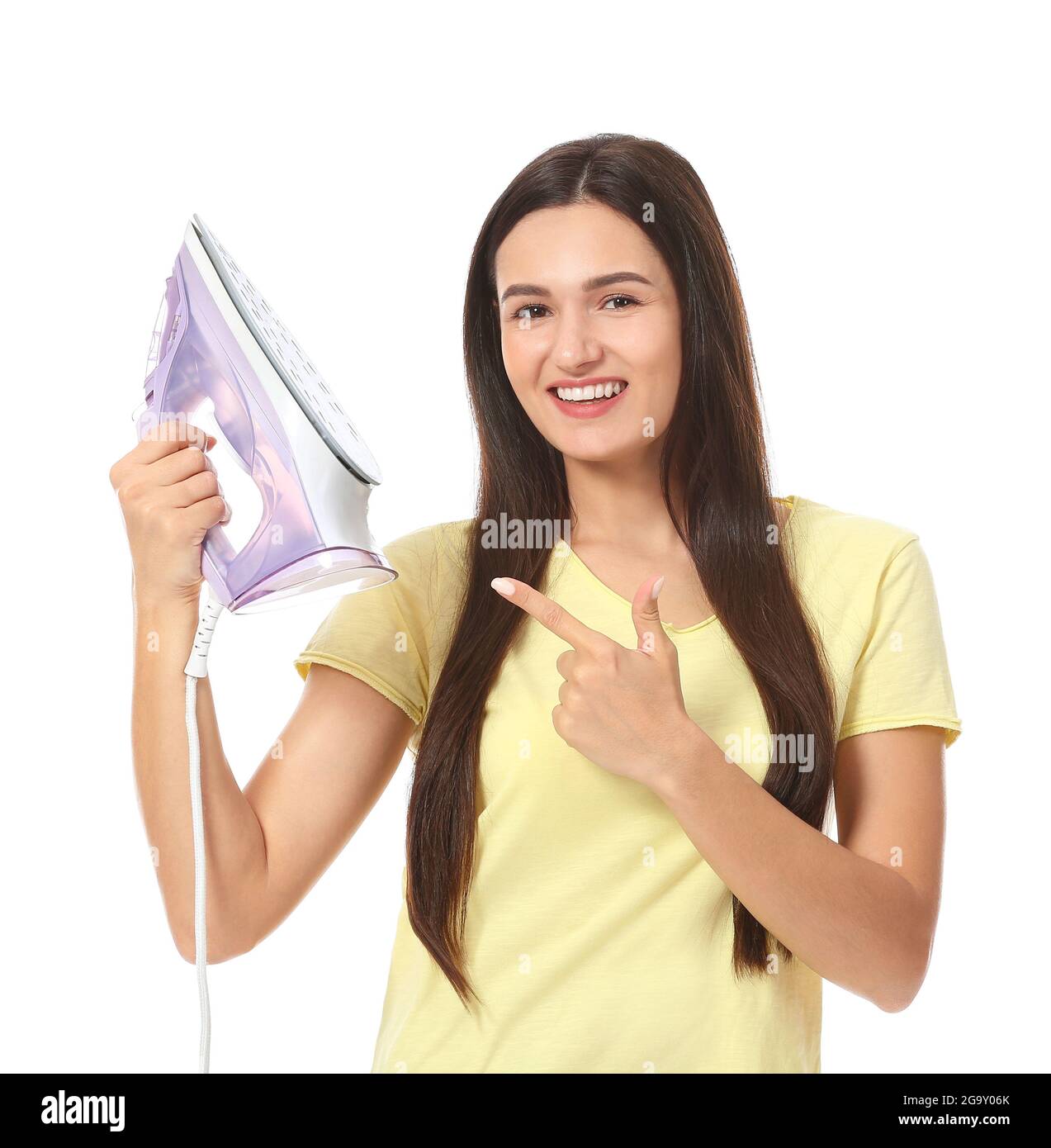 Beautiful young woman pointing at iron on white background Stock Photo ...
