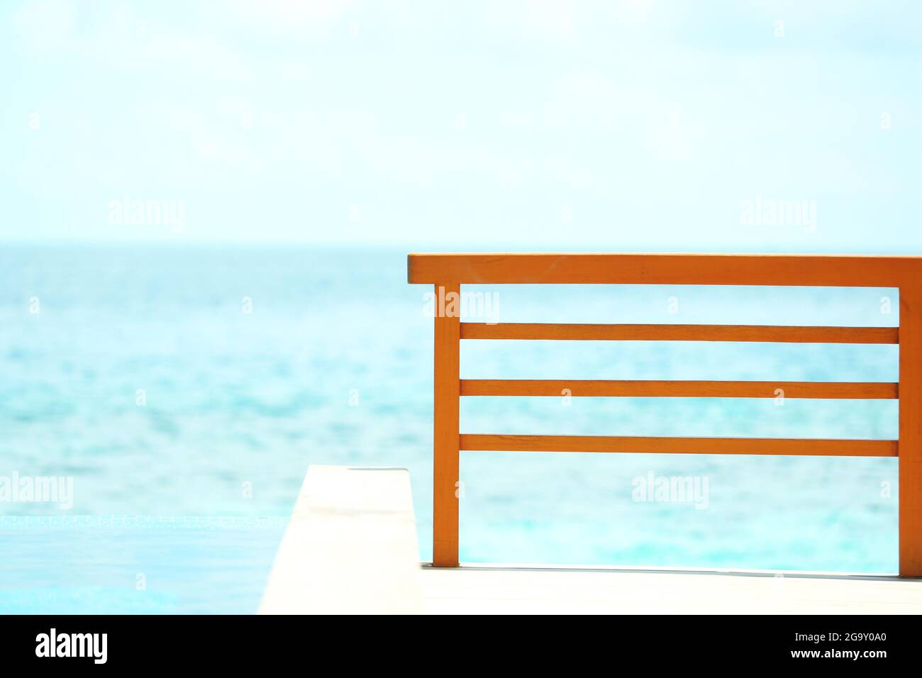Wooden fence over blue ocean background Stock Photo - Alamy