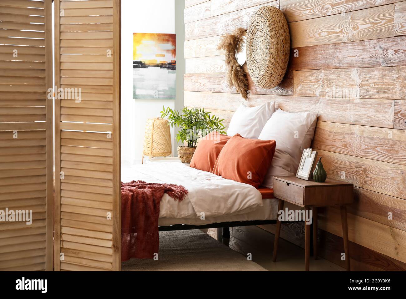Interior of stylish bedroom with folding screen Stock Photo - Alamy
