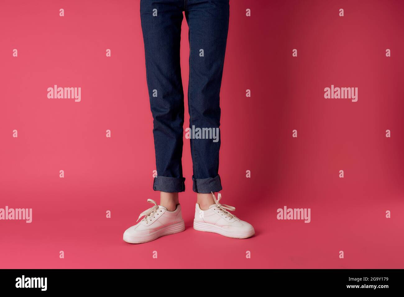 inverted female legs in white sneakers modern style isolated background ...