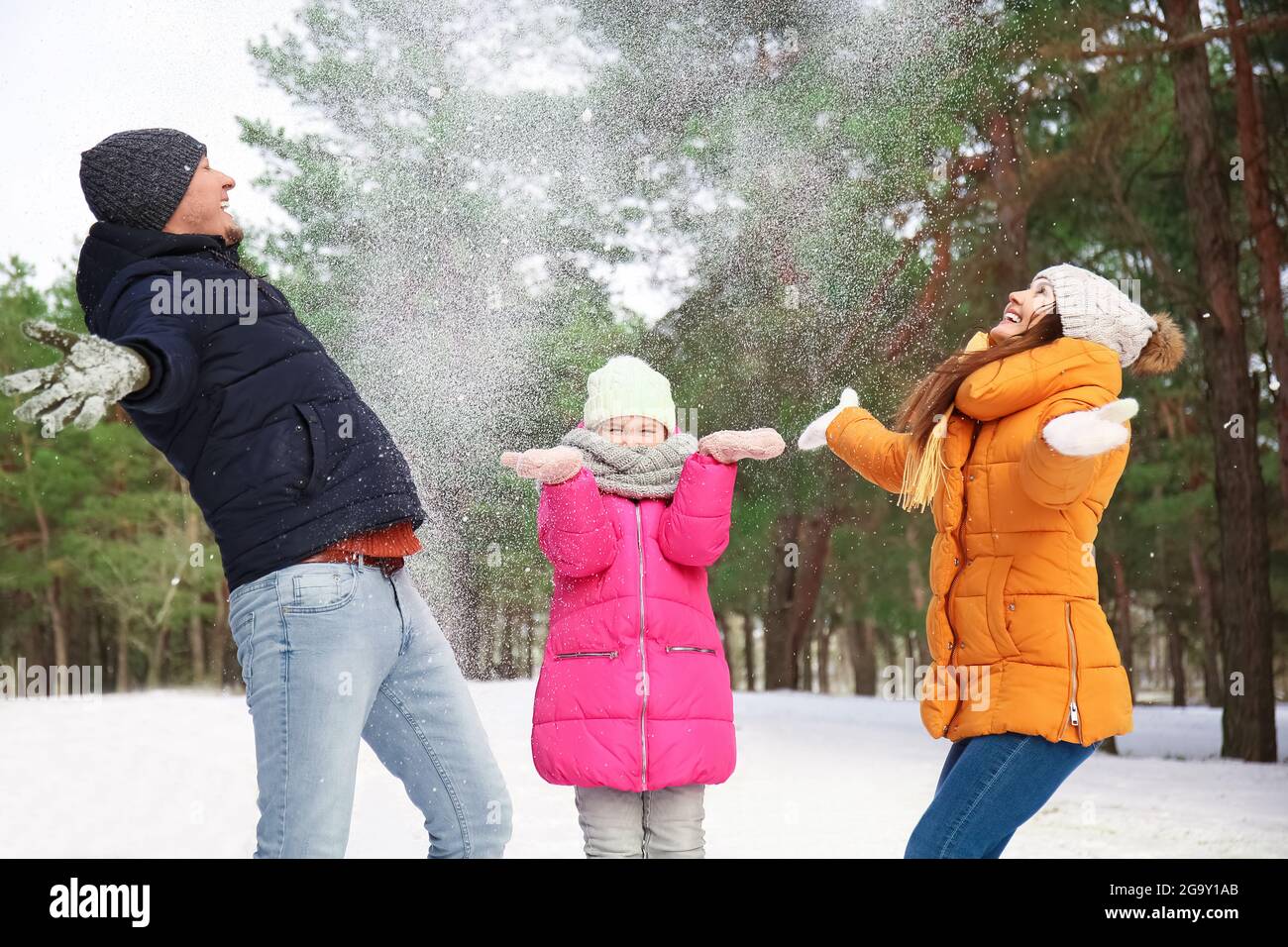 Happy family playing with snow in park on winter day Stock Photo - Alamy