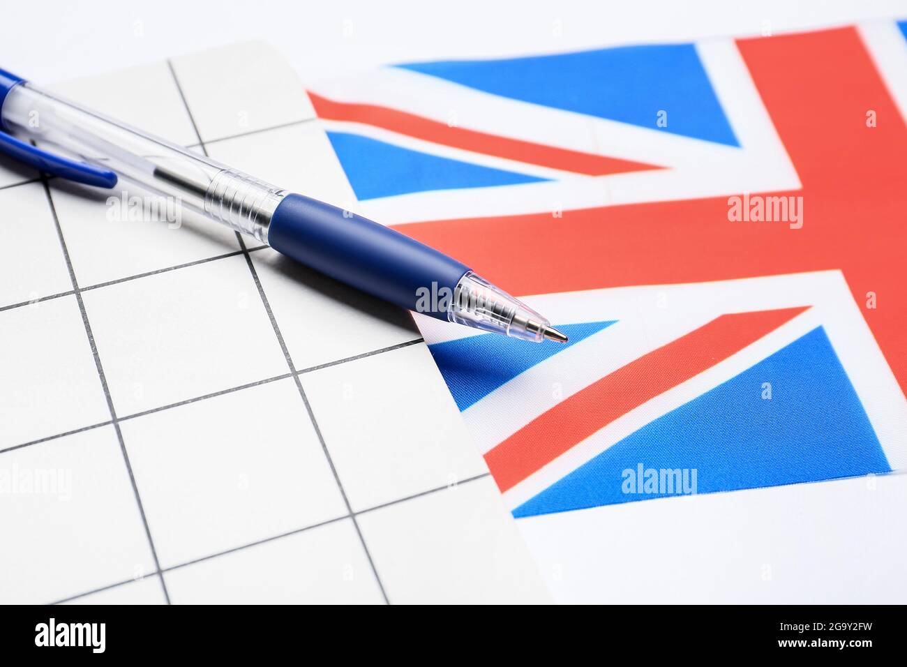 Notebook, pen and UK flag on white background, closeup. Concept of ...