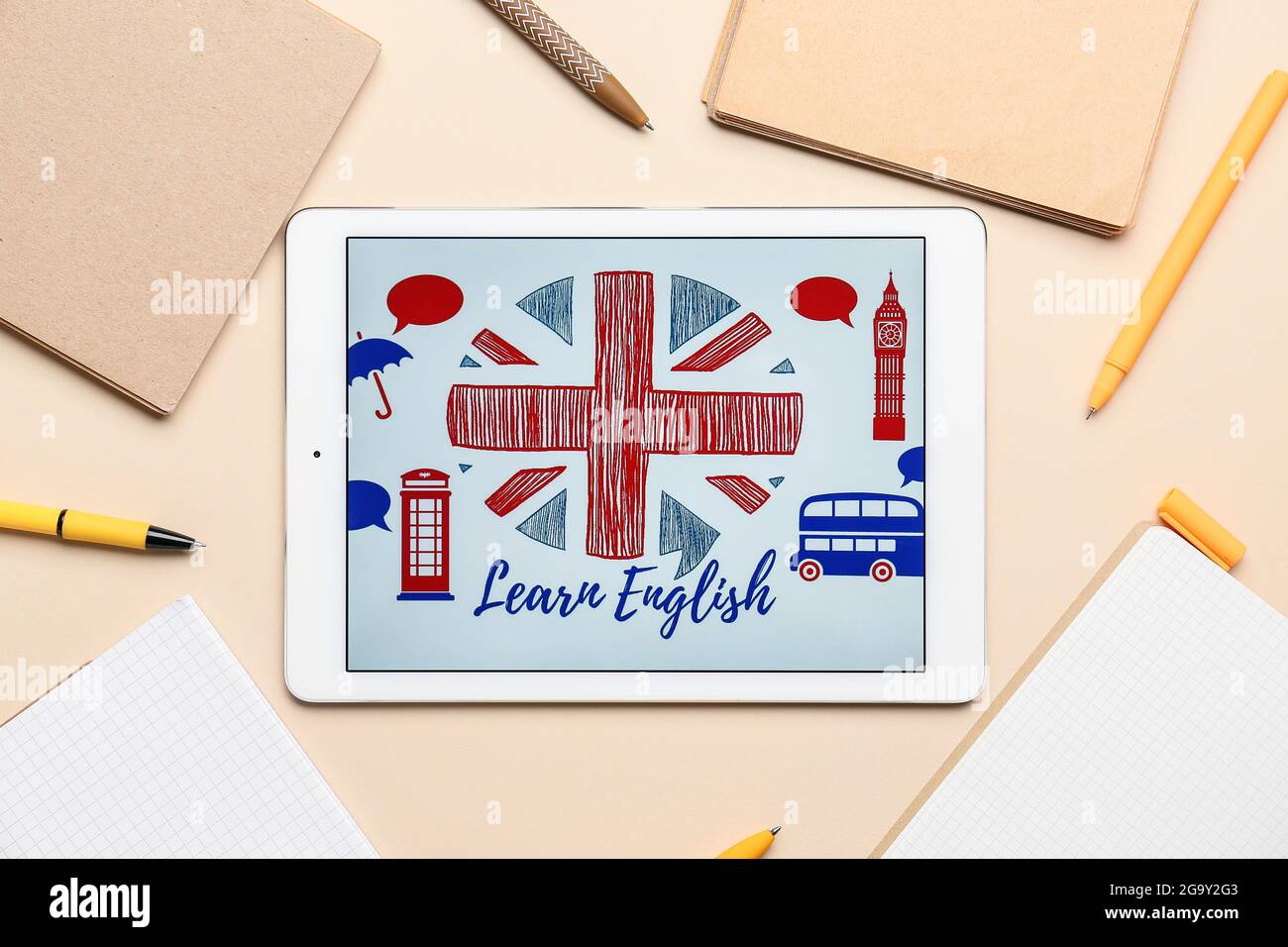 Tablet computer and stationery on color background. Concept of learning ...