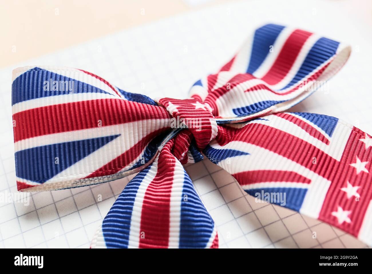 Notebook and ribbon in colors of UK flag, closeup. Concept of learning ...