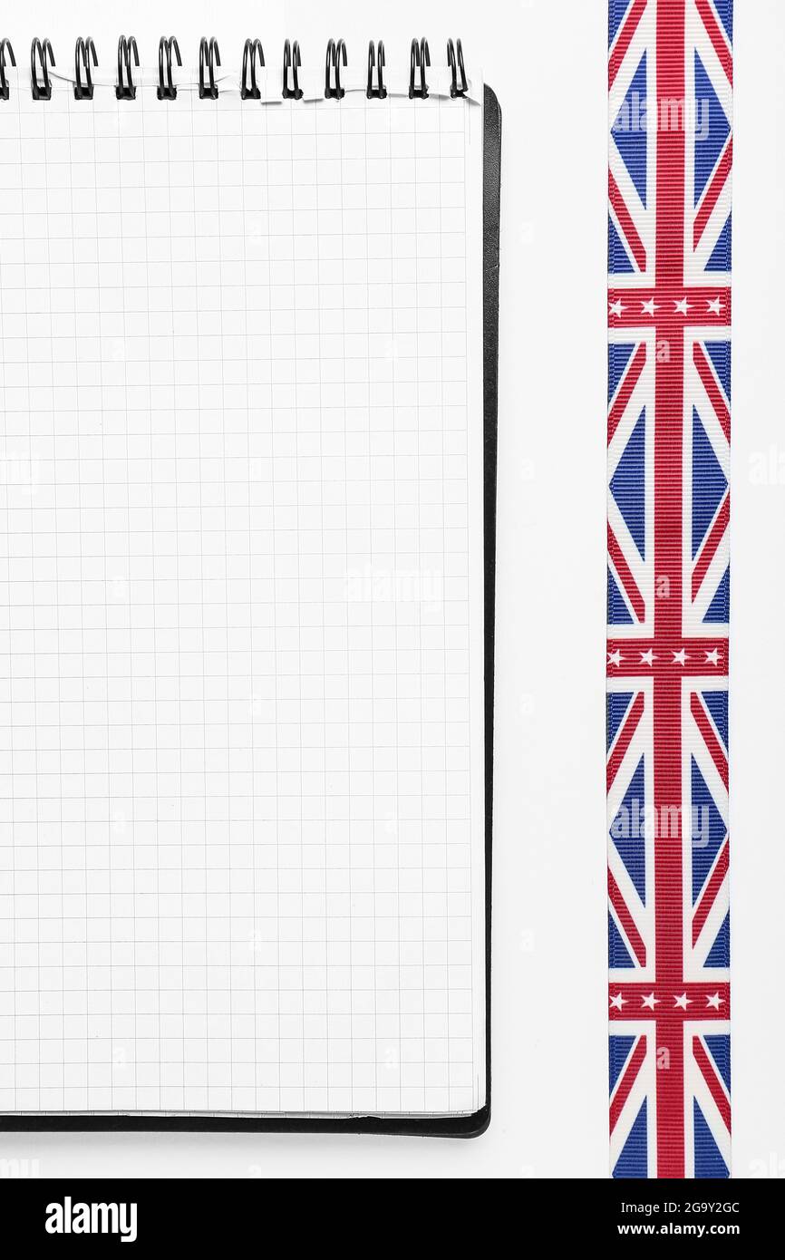 Notebook and ribbon in colors of UK flag on white background. Concept ...