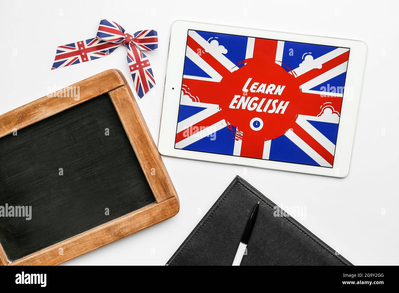 Tablet computer, chalkboard and stationery on white background. Concept ...