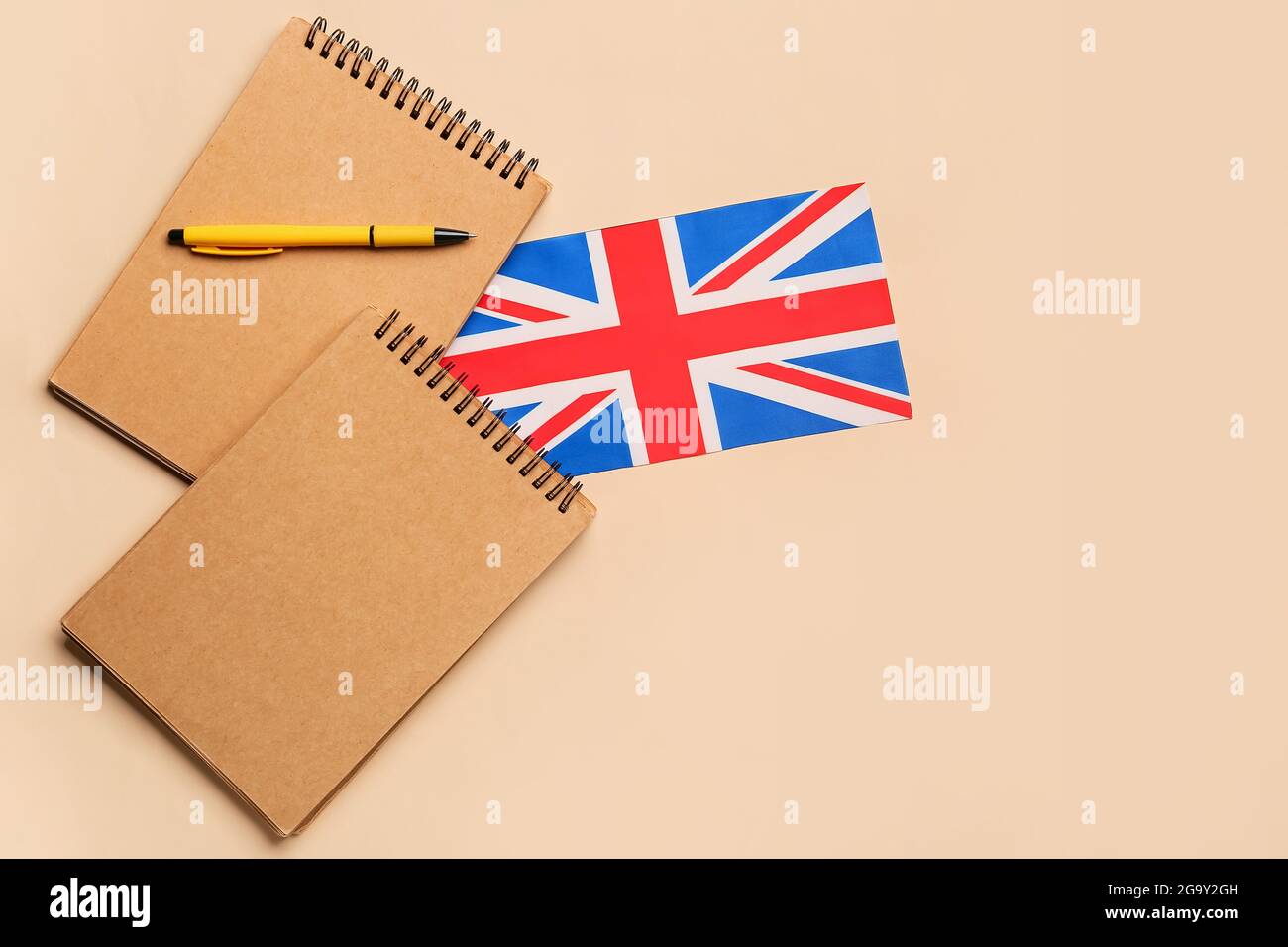 Notebooks, pen and UK flag on color background. Concept of learning ...