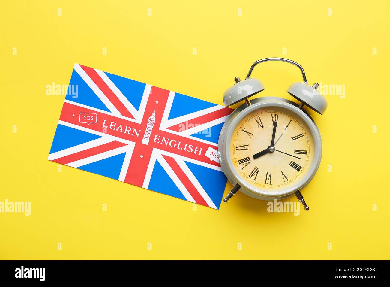 Clock and UK flag on color background. Time to learn English Stock ...