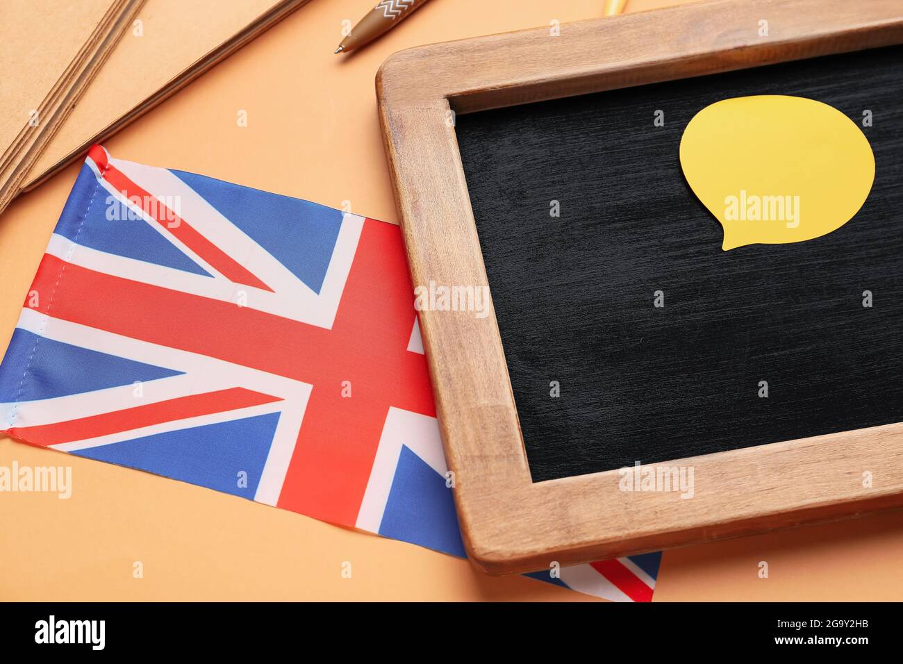 Stationery, chalkboard and UK flag on color background. Concept of ...