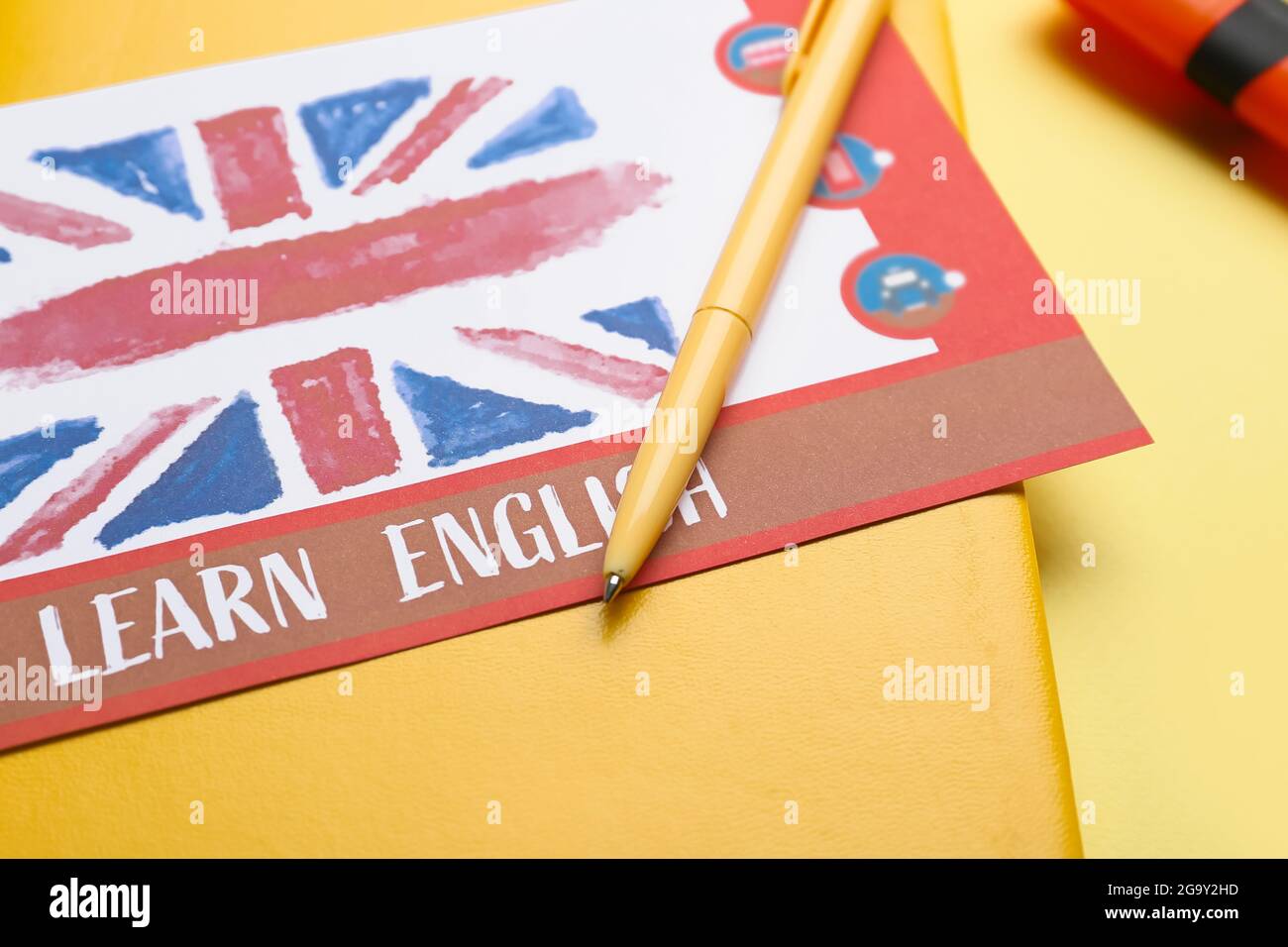 Stationery and paper with text LEARN ENGLISH on color background ...
