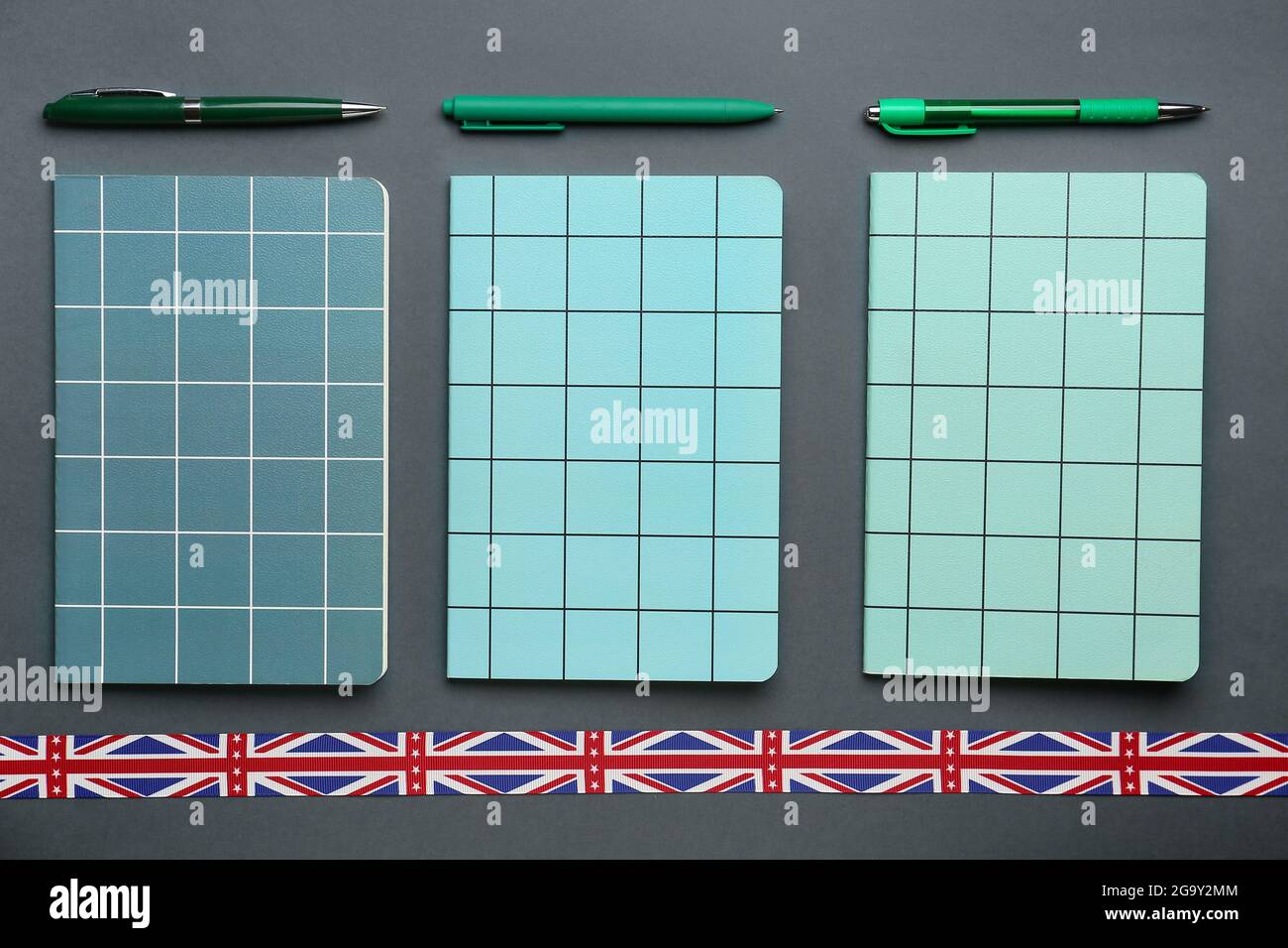 Notebooks and ribbon in colors of UK flag on grey background. Concept ...