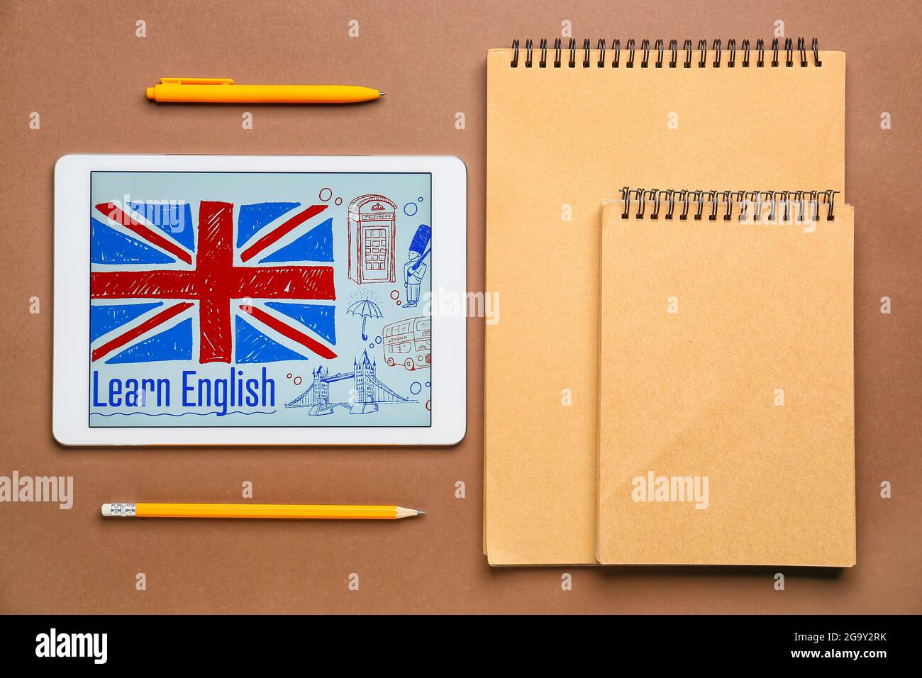 Tablet computer and stationery on color background. Concept of learning ...