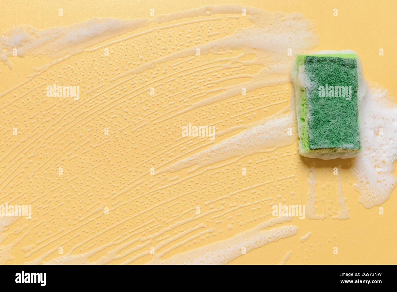 Cleaning sponge with foam on color background Stock Photo - Alamy