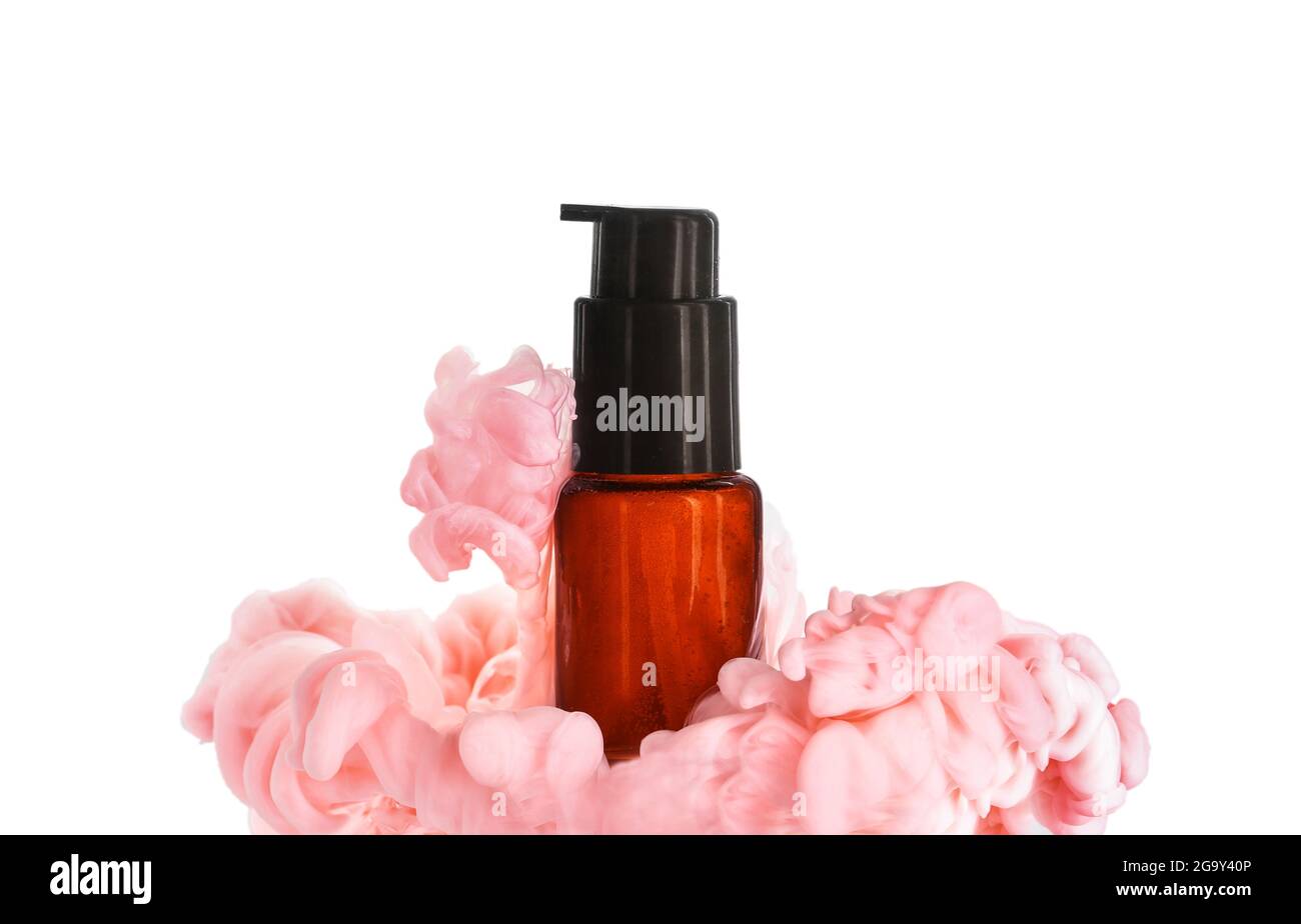Bottle of cosmetic product in color smoke on white background Stock ...