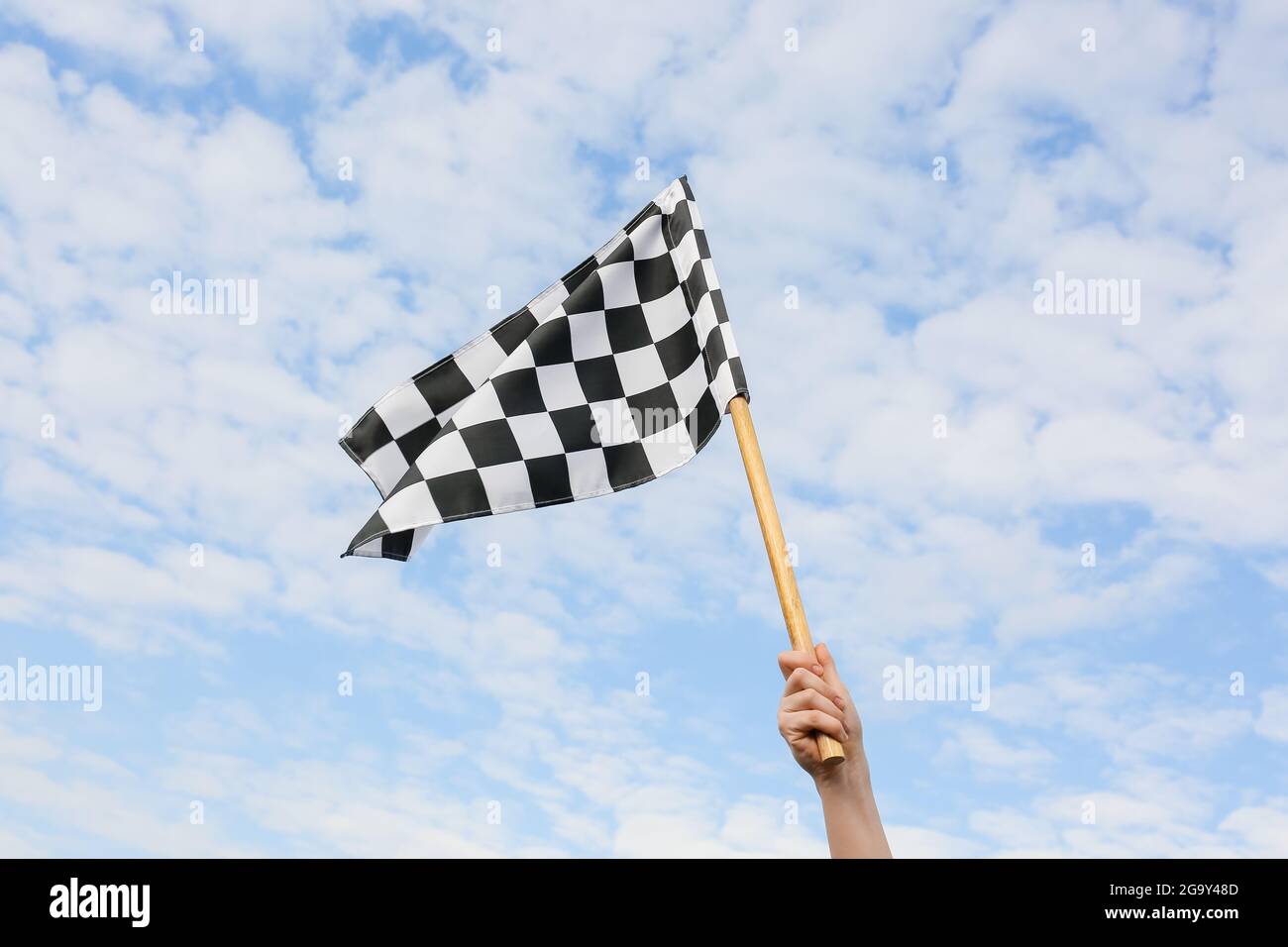 Woman with racing flag outdoors Stock Photo - Alamy