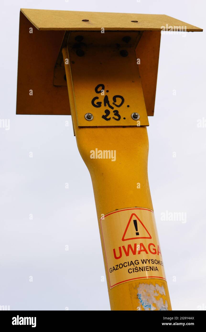 Gas pole with a warning text Stock Photo - Alamy