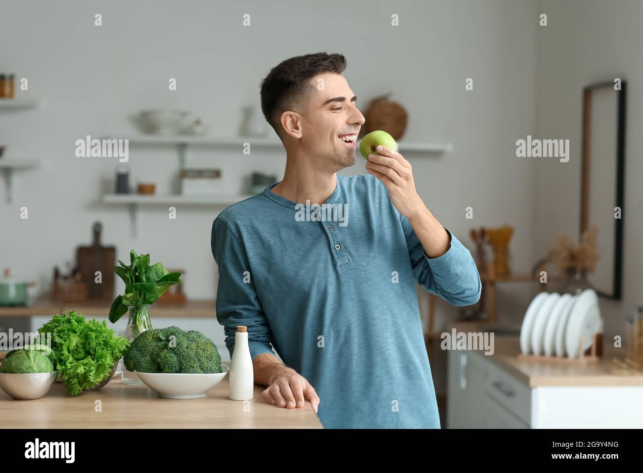 Young man eating tasty apple hi-res stock photography and images - Alamy