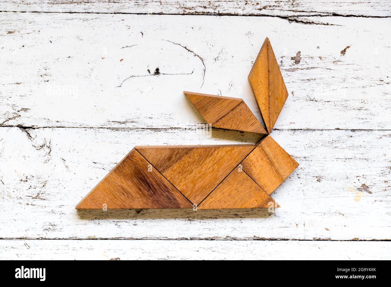 Tangram puzzle in rabbit shape on old white wood background Stock Photo ...