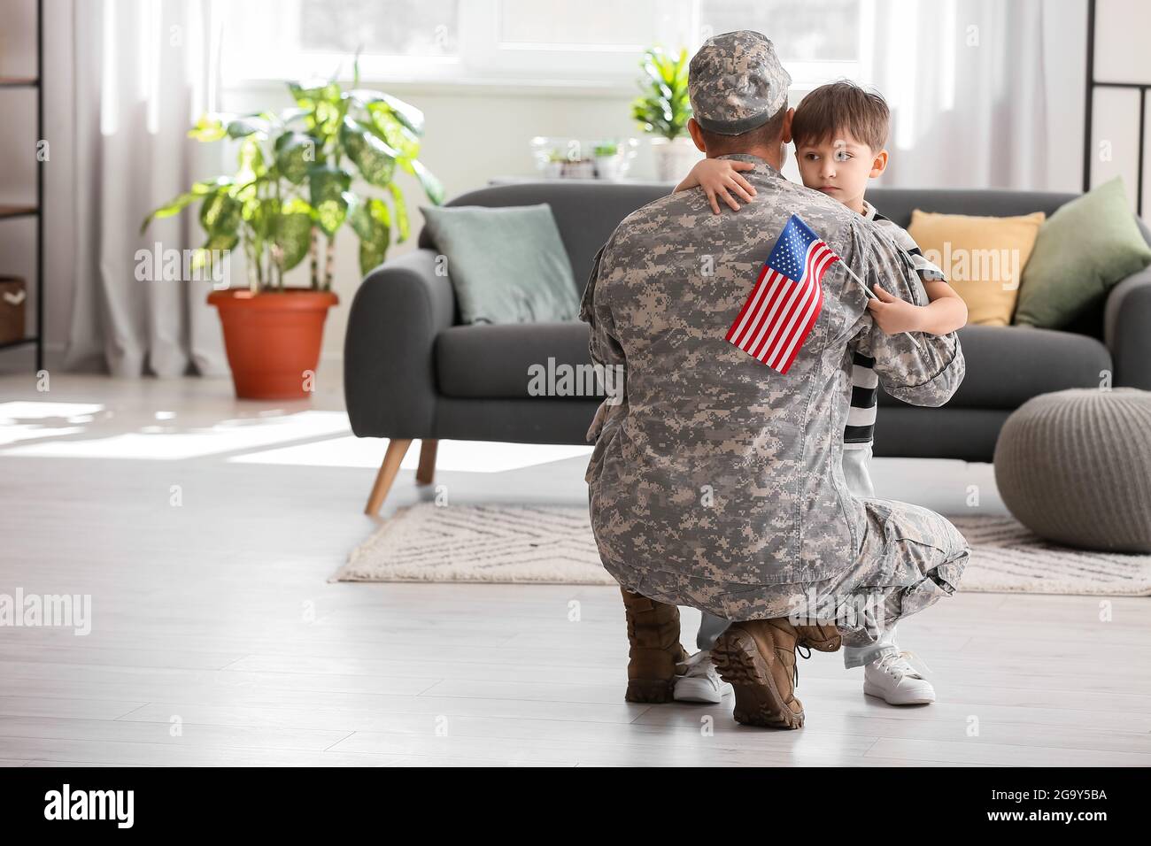 Soldier and his little son hugging at home. Memorial Day celebration ...
