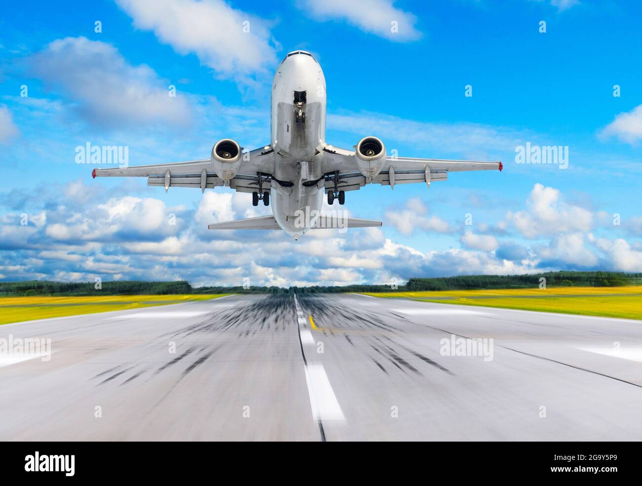 Passenger airplane fly up over take off runway from airport Stock Photo ...