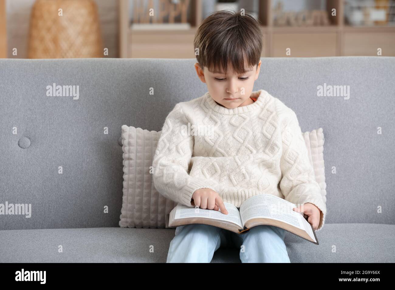 Little boy reading Bible at home Stock Photo - Alamy