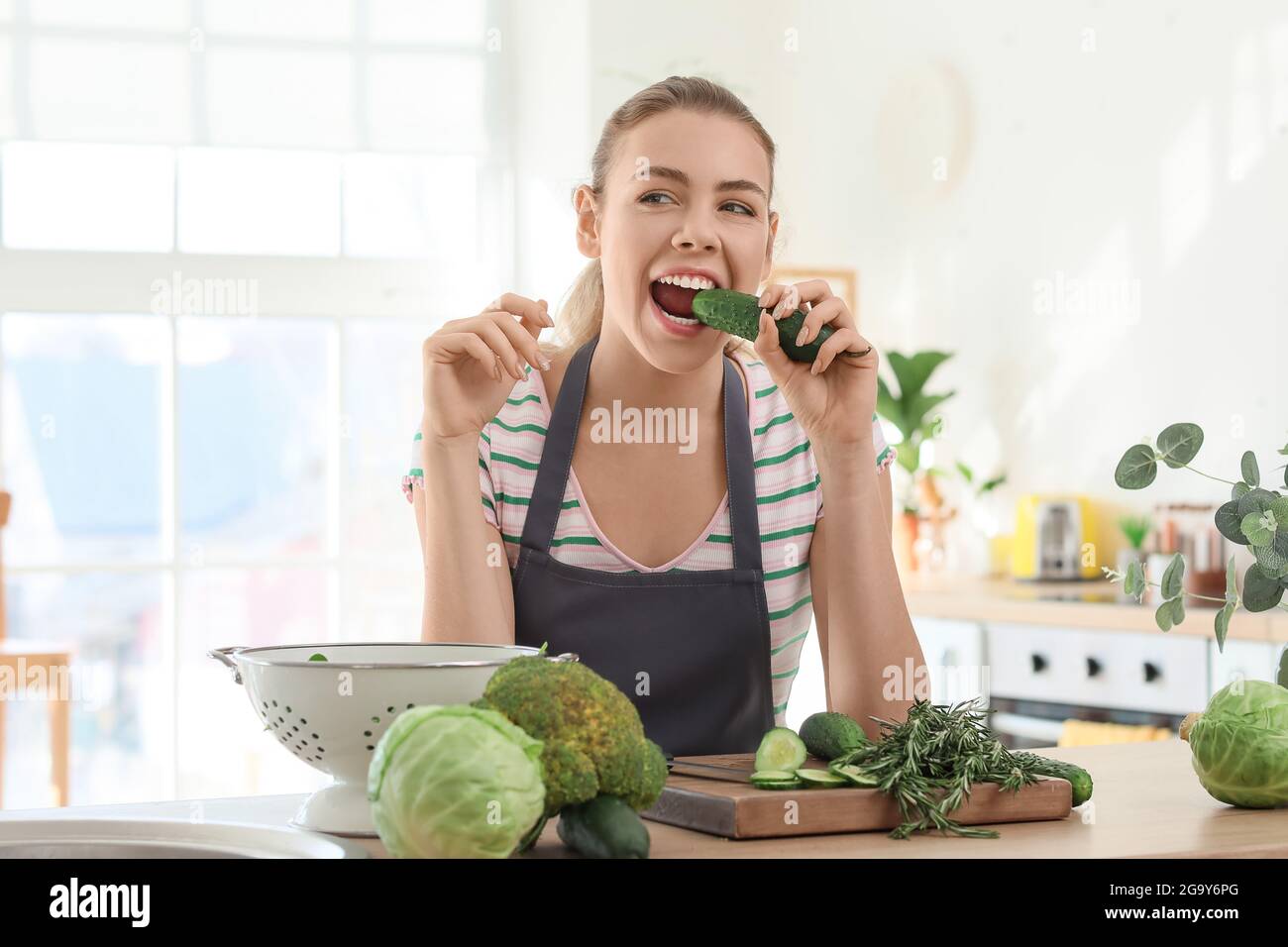 Woman eating cucumber hi-res stock photography and images - Alamy