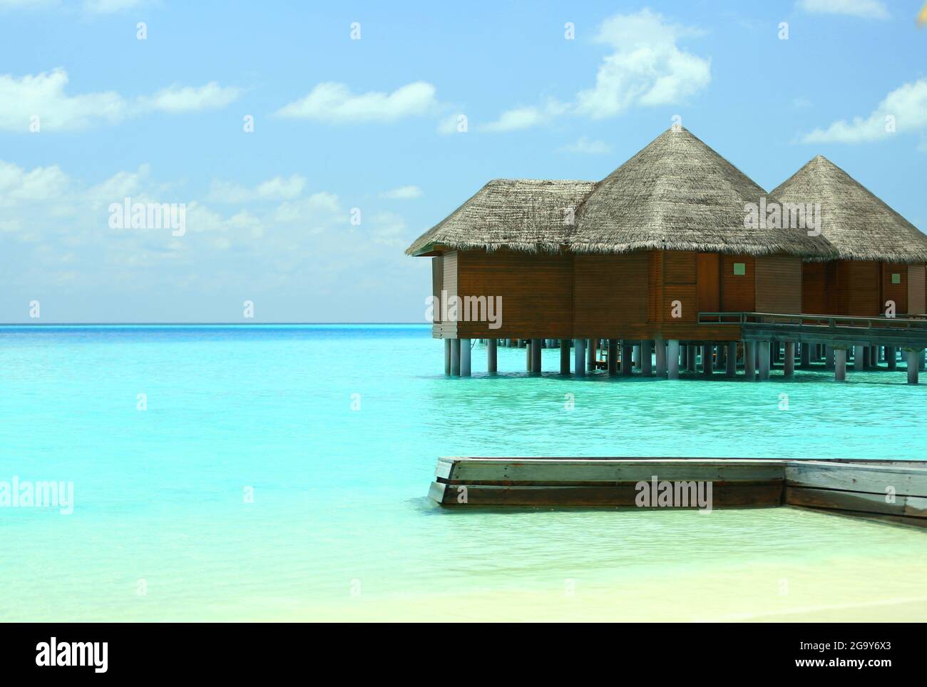 Water villas over ocean background Stock Photo - Alamy