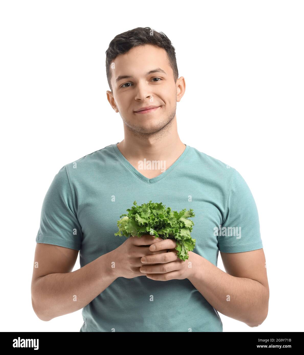 Young man with fresh lettuce on white background Stock Photo - Alamy