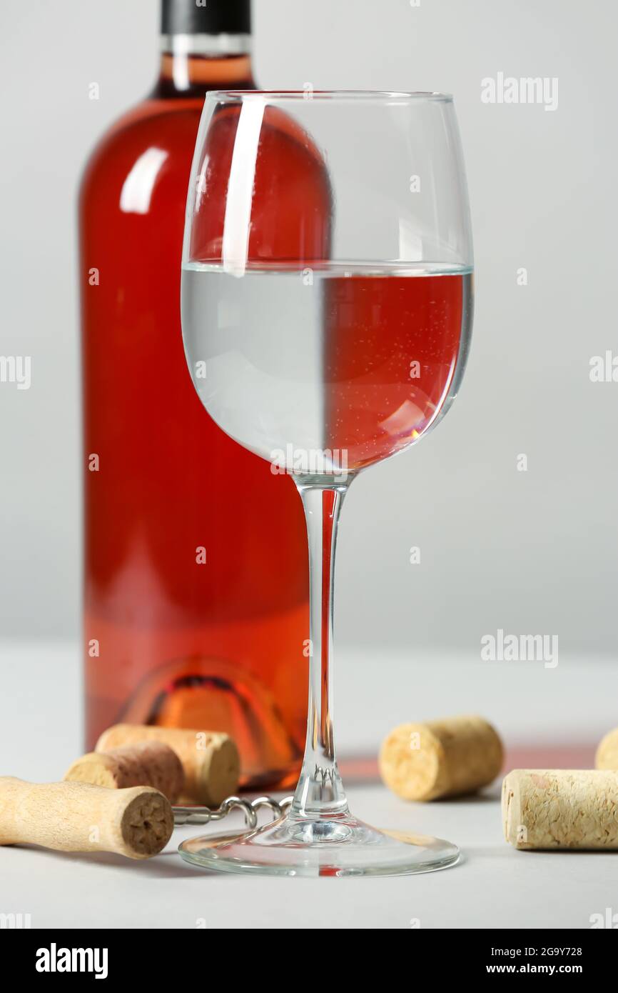 Bottle of exquisite wine and glass on light background Stock Photo - Alamy