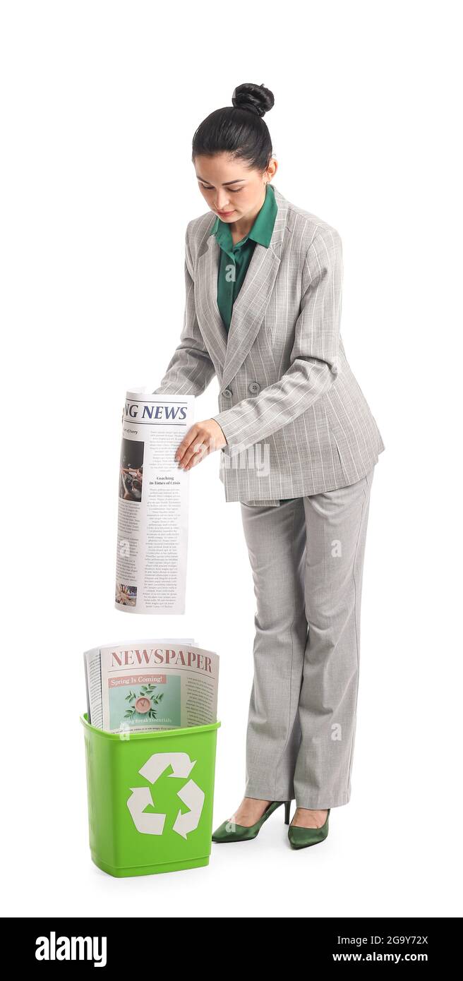 Young businesswoman throwing newspaper into recycle bin on white ...